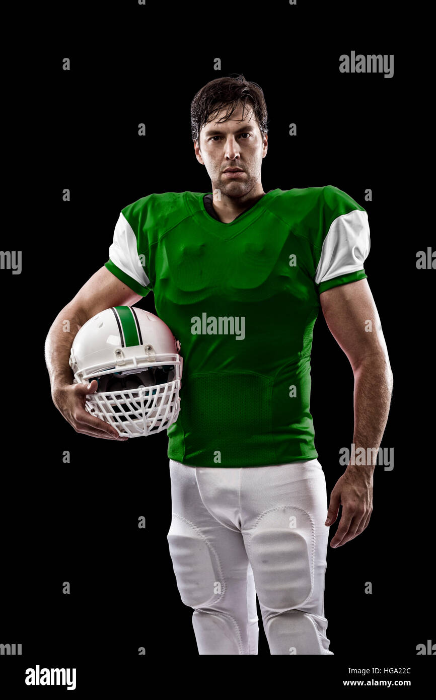 Football Player with a Green uniform on a black background Stock Photo ...