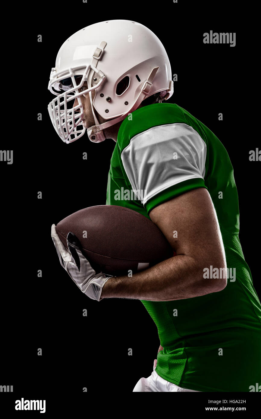 Football Player with a Green uniform Running on a black background ...