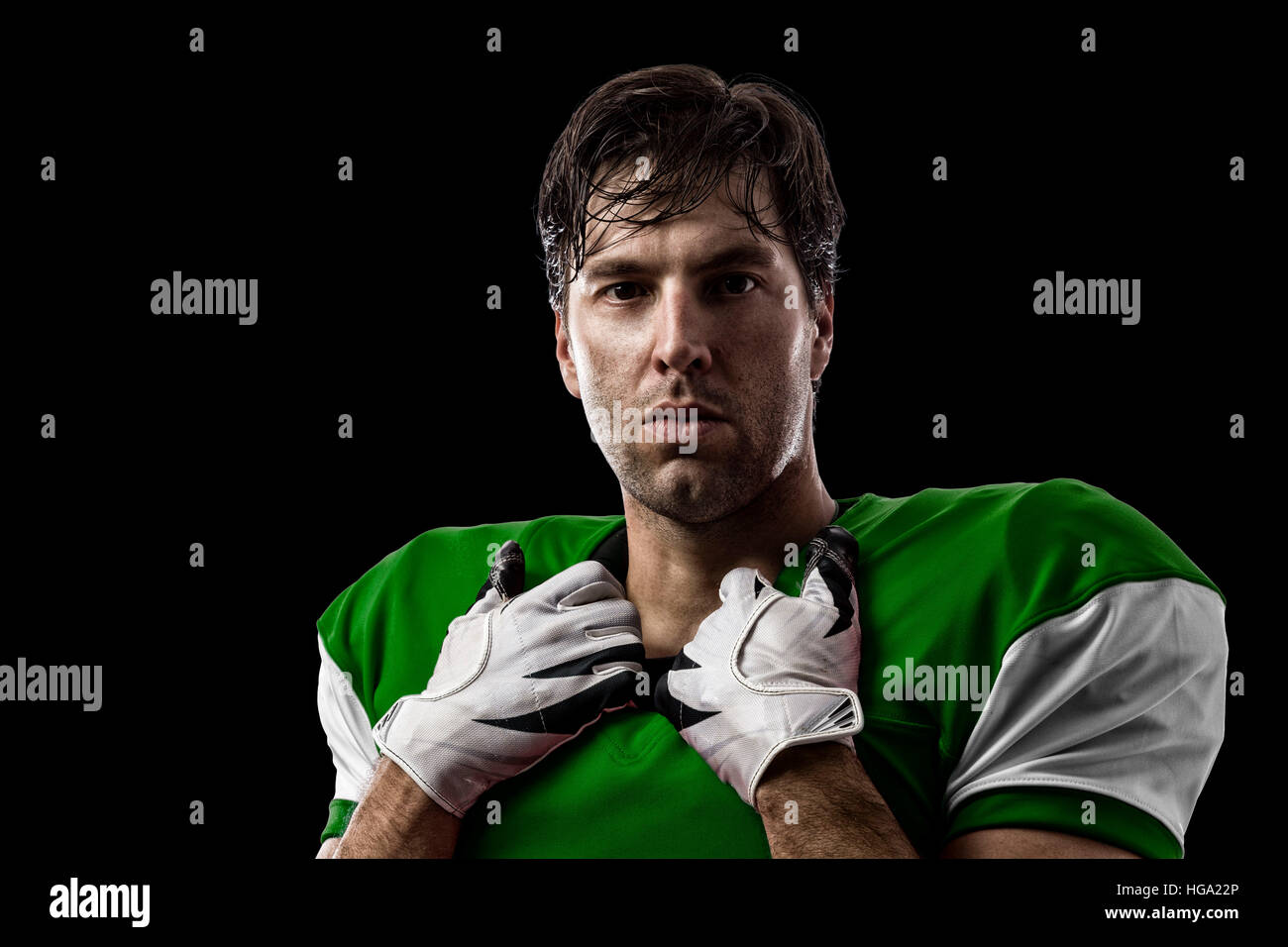 Football Player with a Green uniform on a black background Stock Photo ...