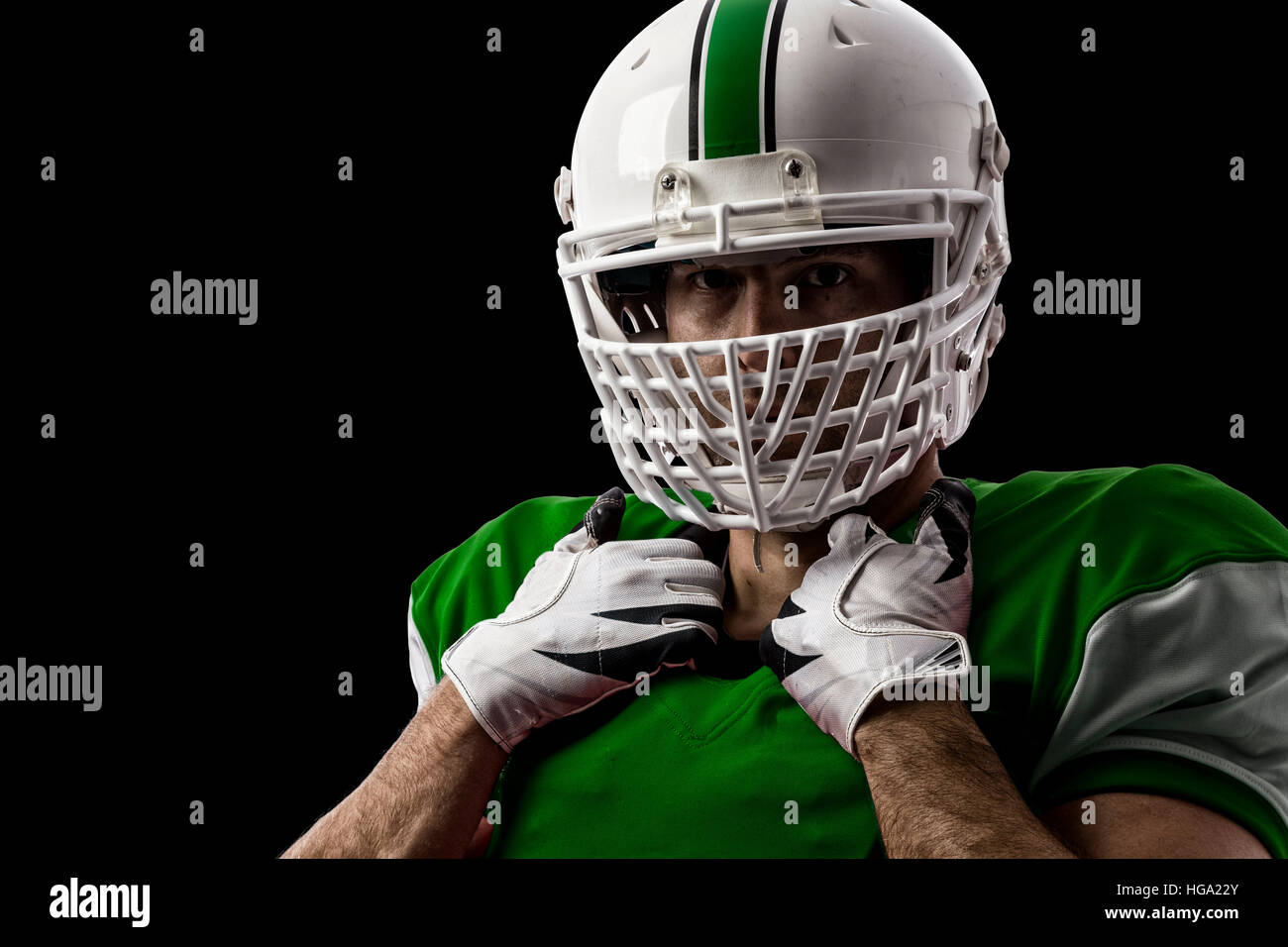 Football Player with a Green uniform on a black background Stock Photo ...