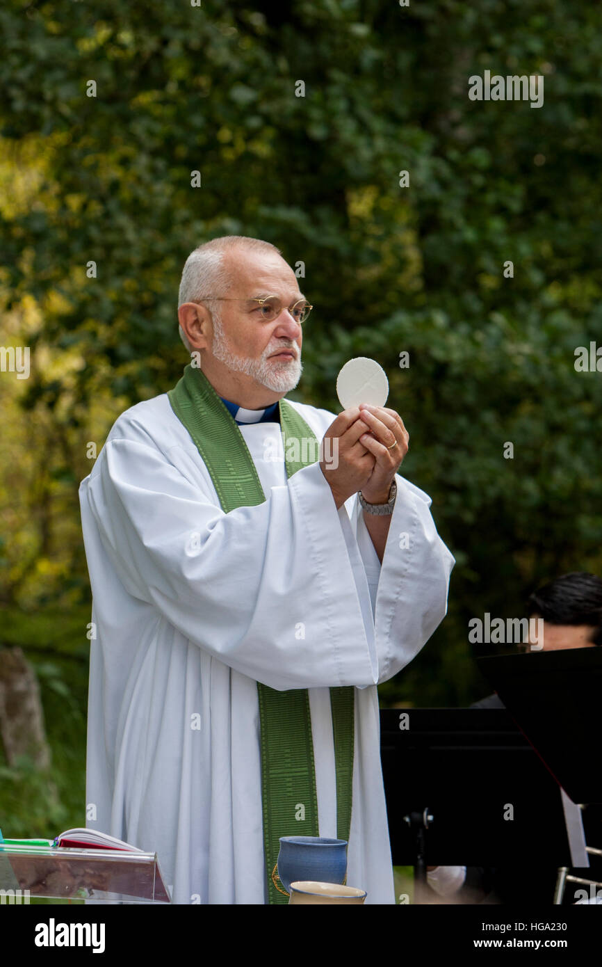 The priest breaks the bread at a church service Stock Photo - Alamy