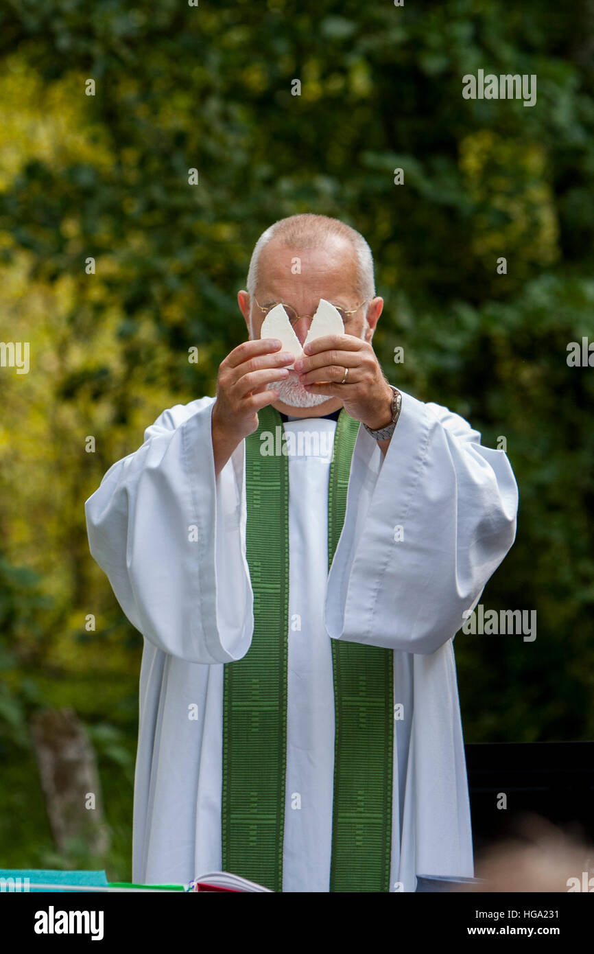 The priest breaks the bread at a church service Stock Photo - Alamy