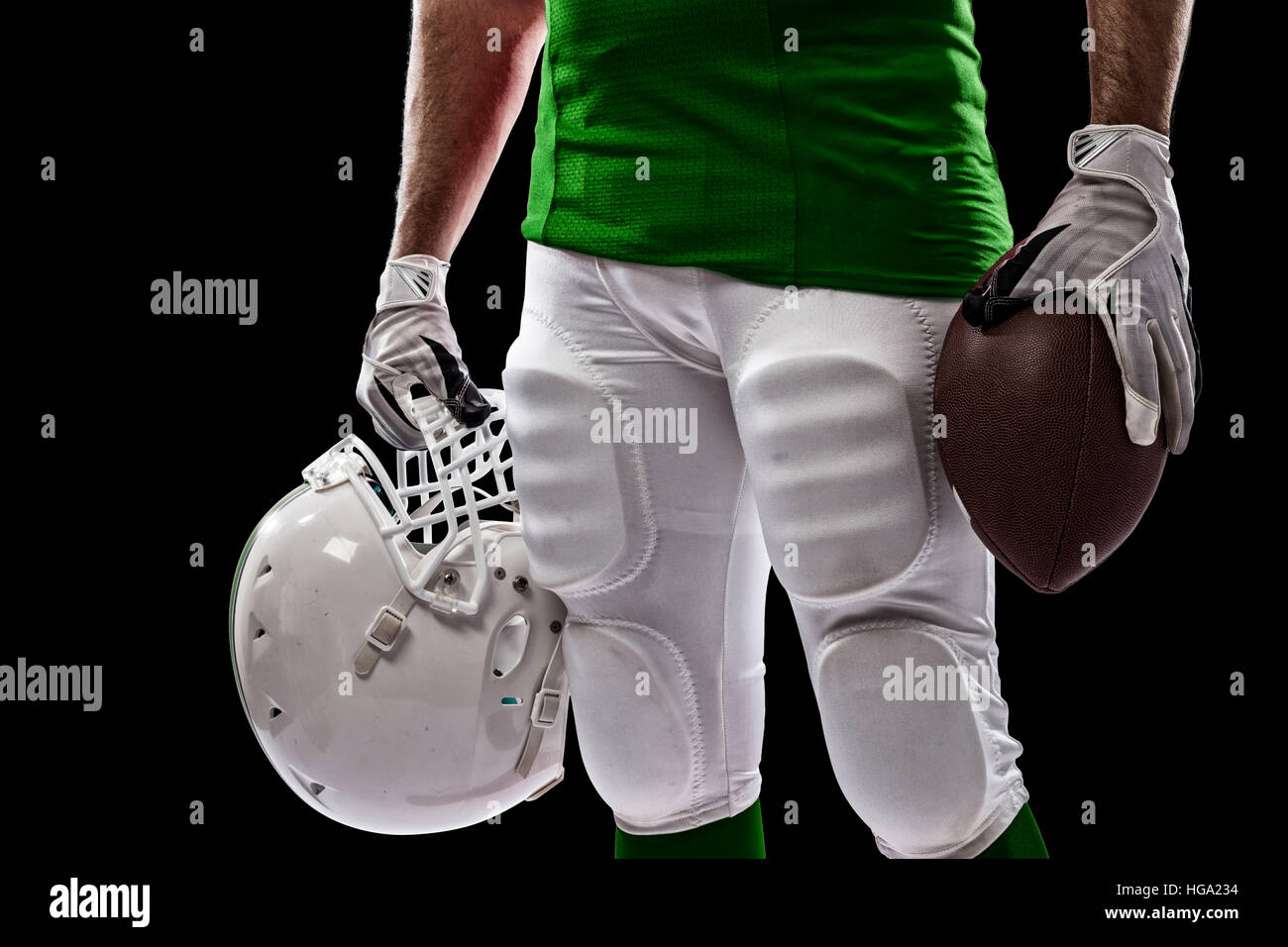 Football Player with a Green uniform on a black background Stock Photo ...