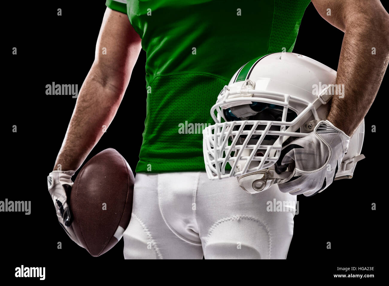 Football Player with a Green uniform on a black background Stock Photo ...