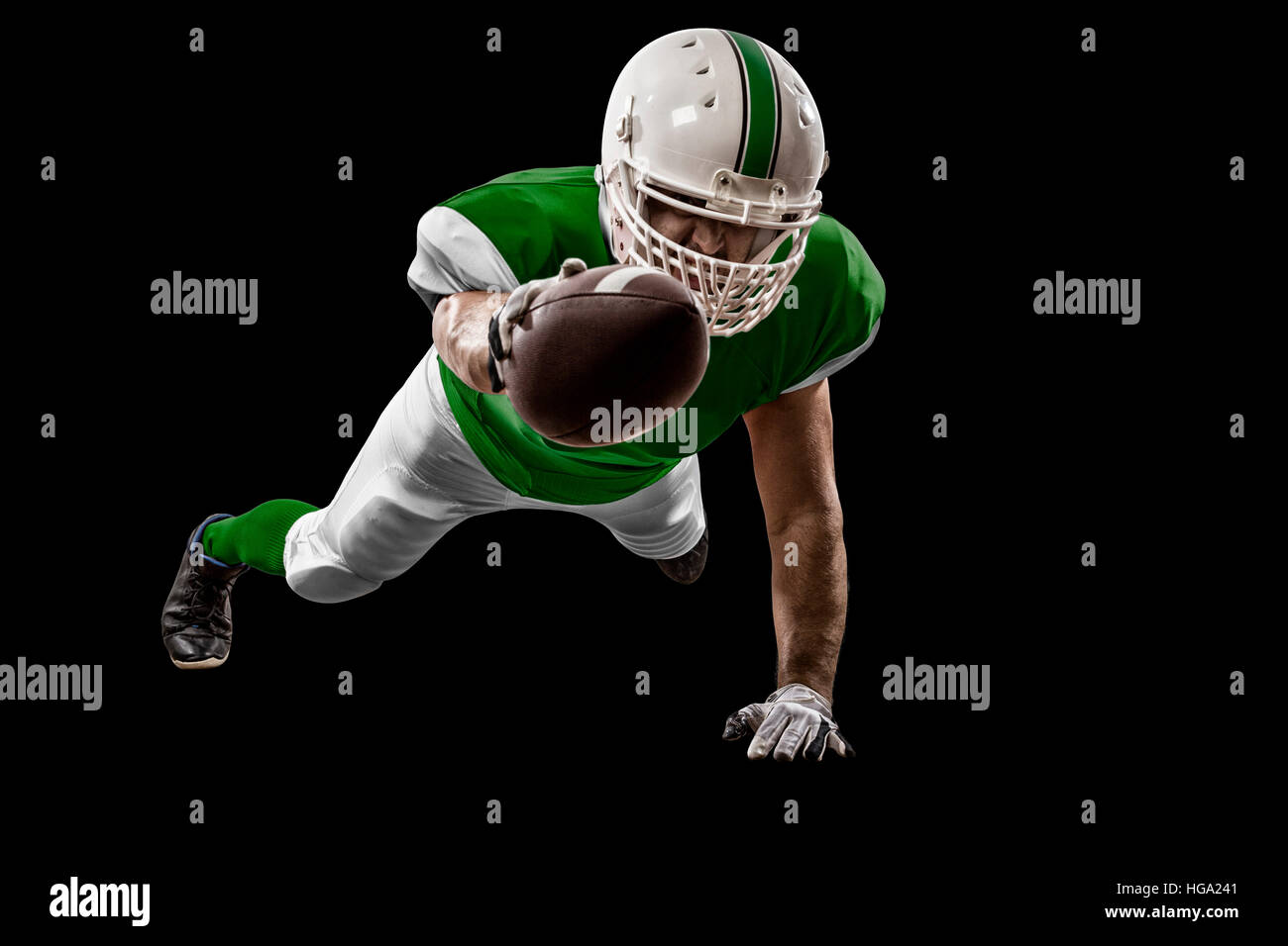 Football Player with a Green uniform scoring on a black background ...