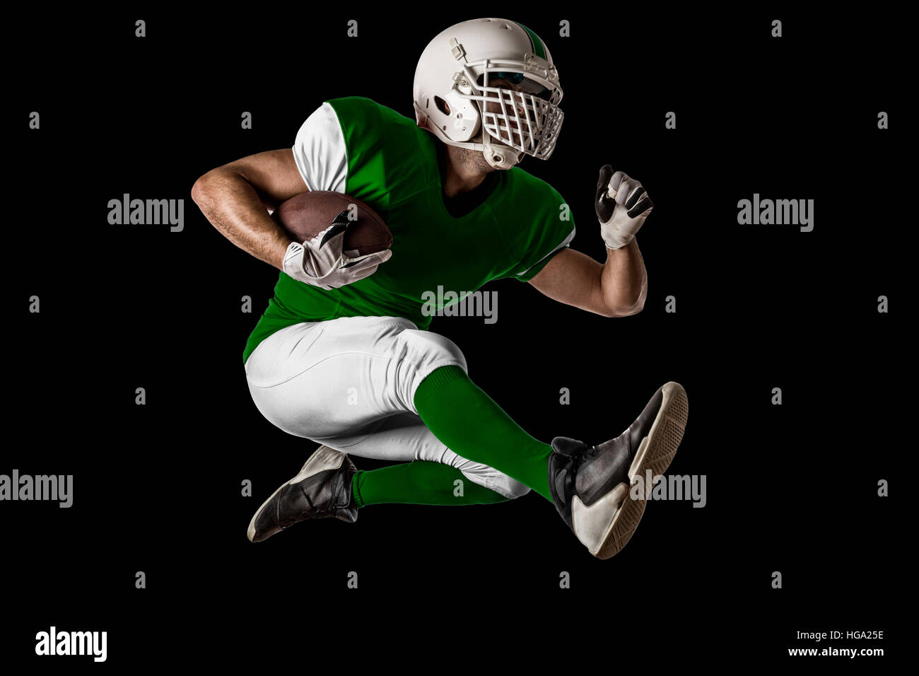 Football Player with a Green uniform Running on a black background ...