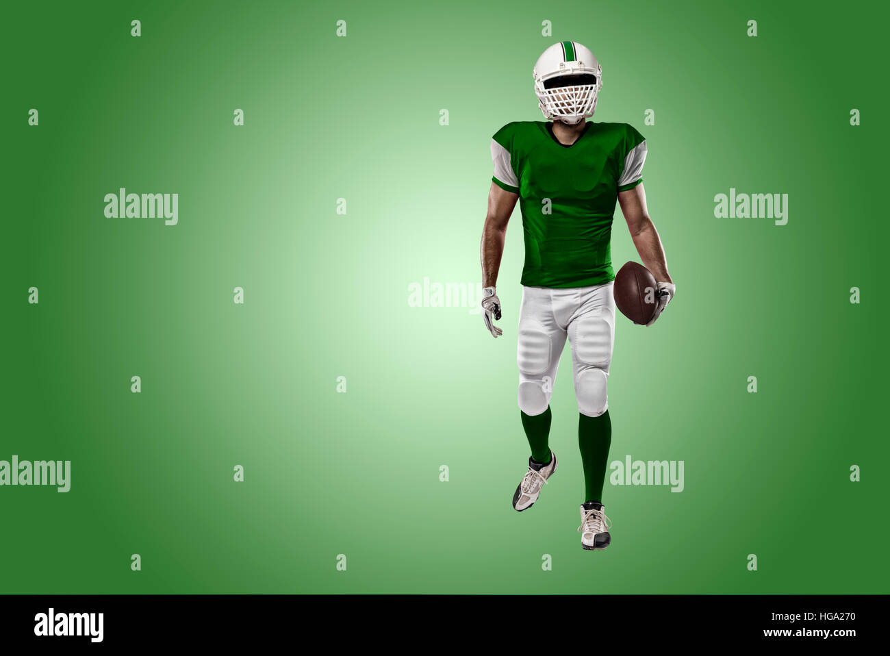 Football Player with a green uniform on a green background Stock Photo ...