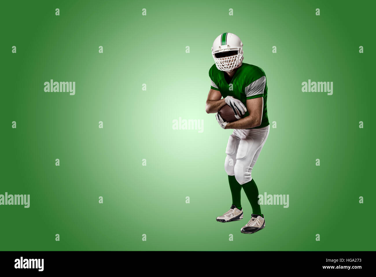 Football Player with a green uniform on a green background Stock Photo ...