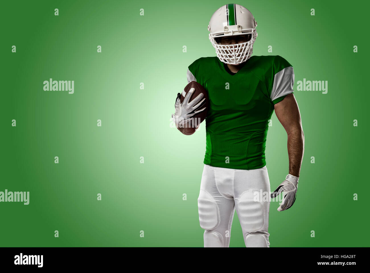 Football Player with a green uniform on a green background Stock Photo ...