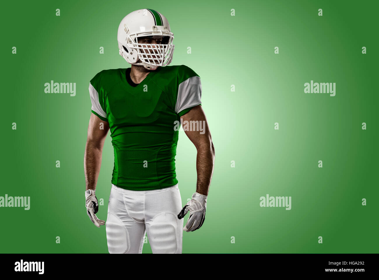 Football Player with a green uniform on a green background Stock Photo ...
