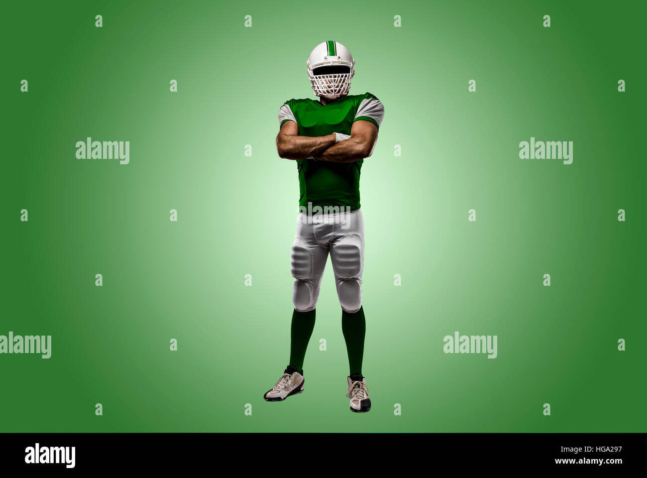 Football Player with a green uniform on a green background Stock Photo ...