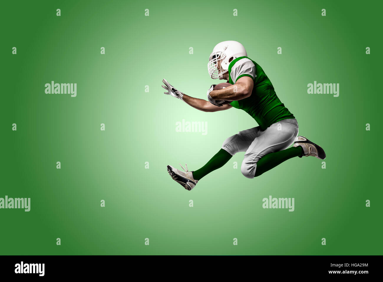 Football Player with a green uniform Running on a green background ...