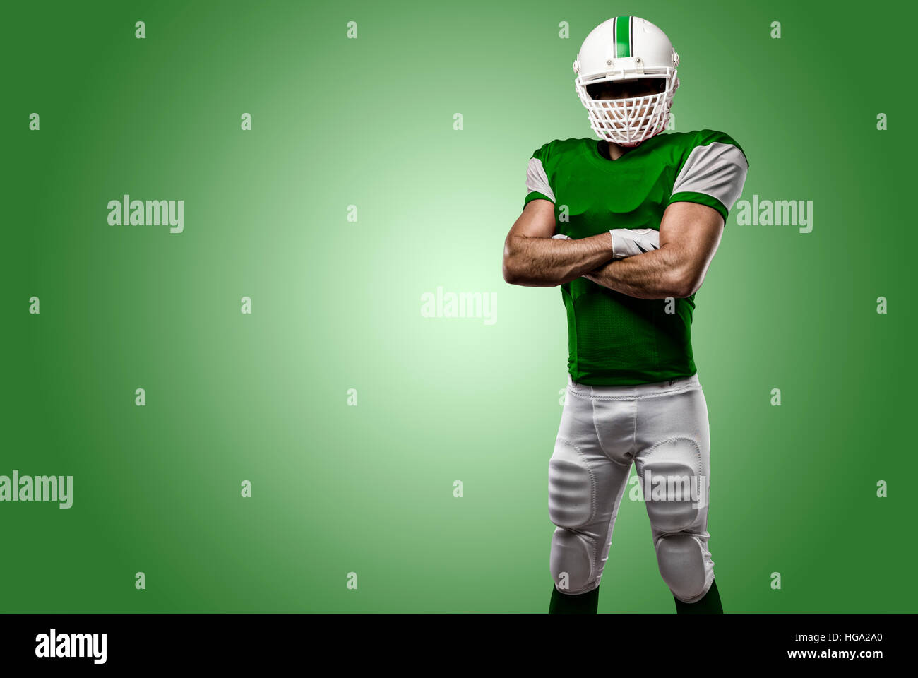 Football Player with a green uniform on a green background Stock Photo ...