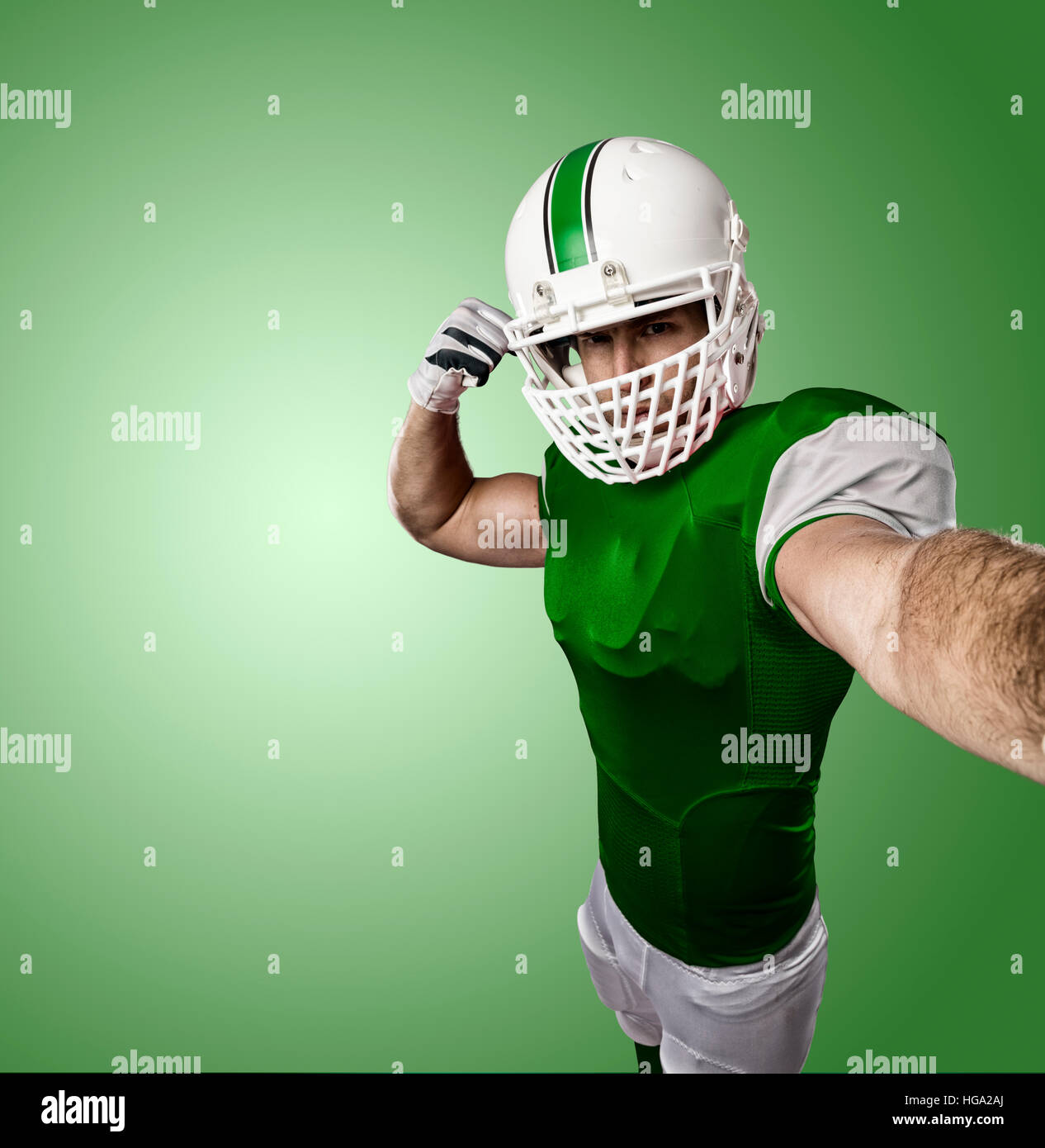 Football Player with a green uniform making a selfie on a green ...