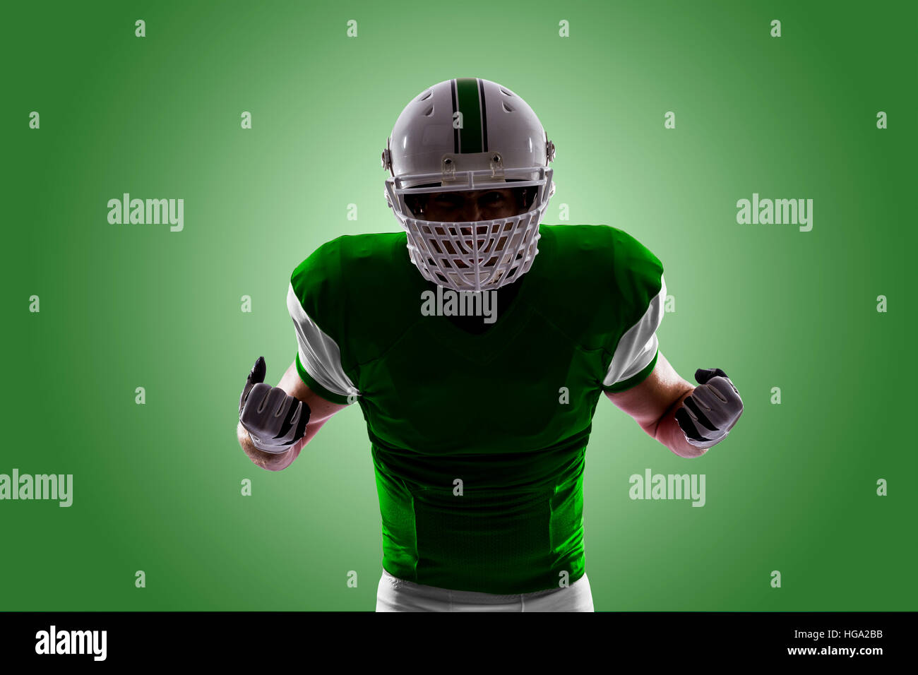Football Player with a green uniform on a green background Stock Photo ...