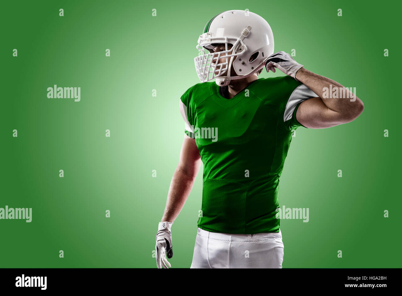 Football Player with a green uniform on a green background Stock Photo ...