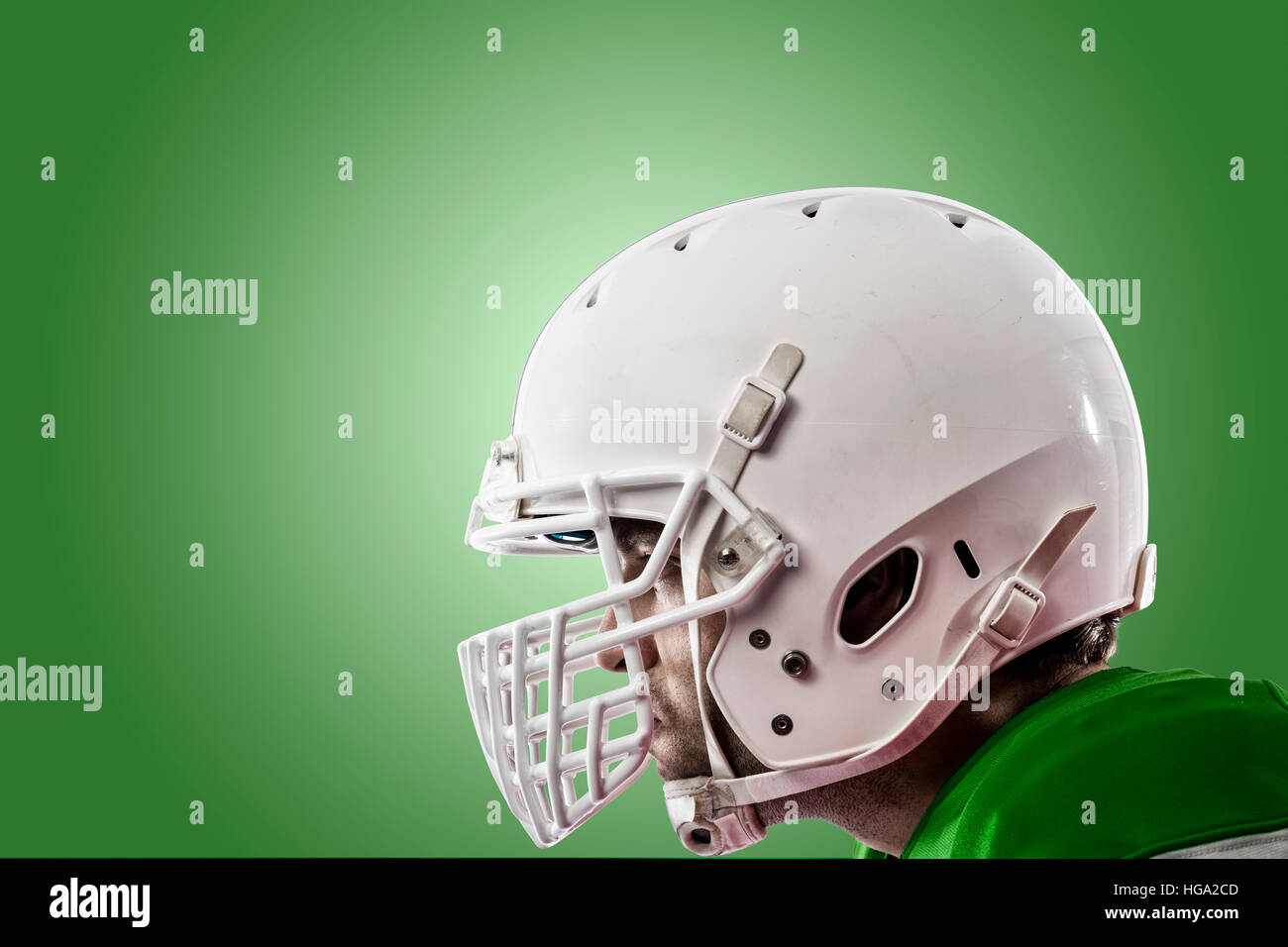 Close up of a Football Player with a green uniform on a green ...