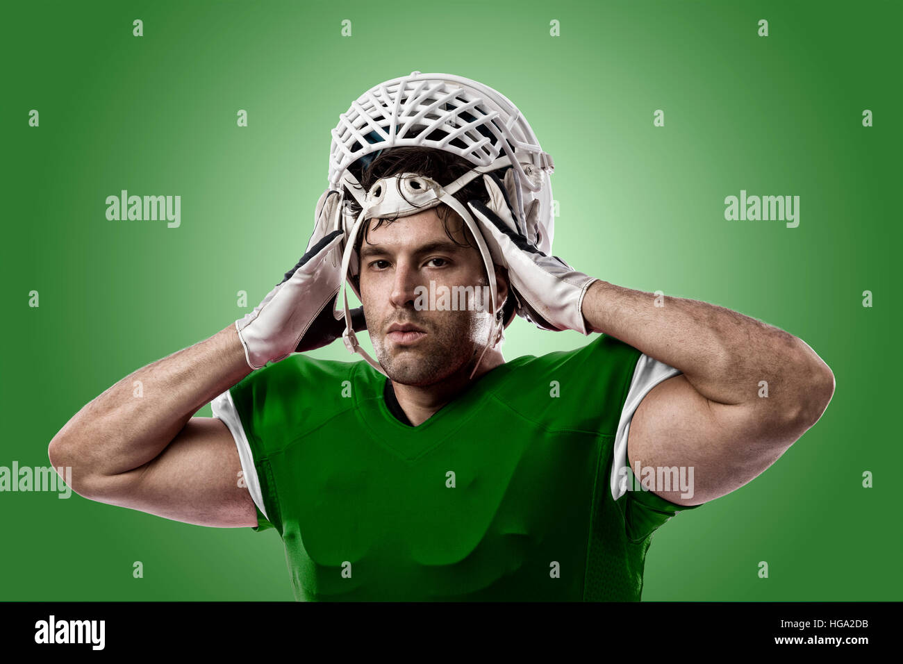 Football Player with a green uniform on a green background Stock Photo ...