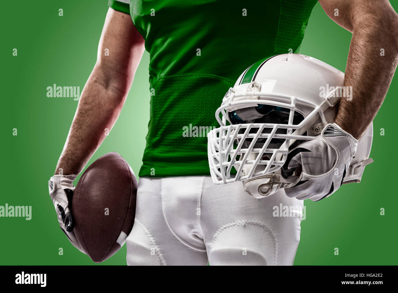 Football Player with a green uniform on a green background Stock Photo ...
