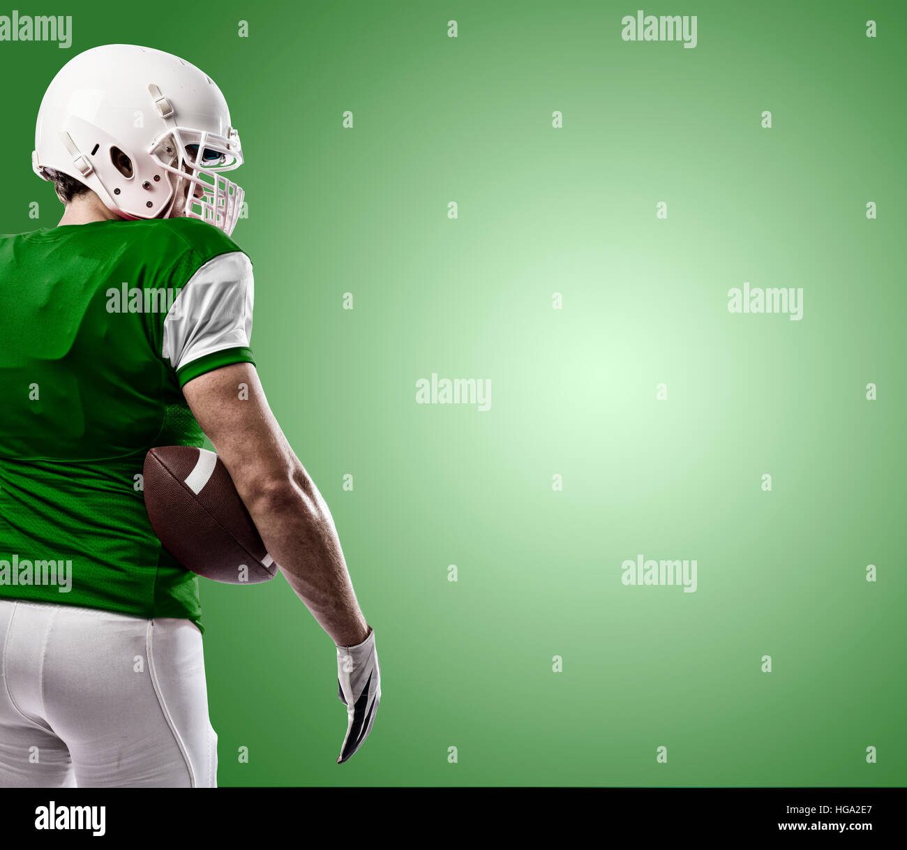 Football Player with a green uniform on a green background Stock Photo ...