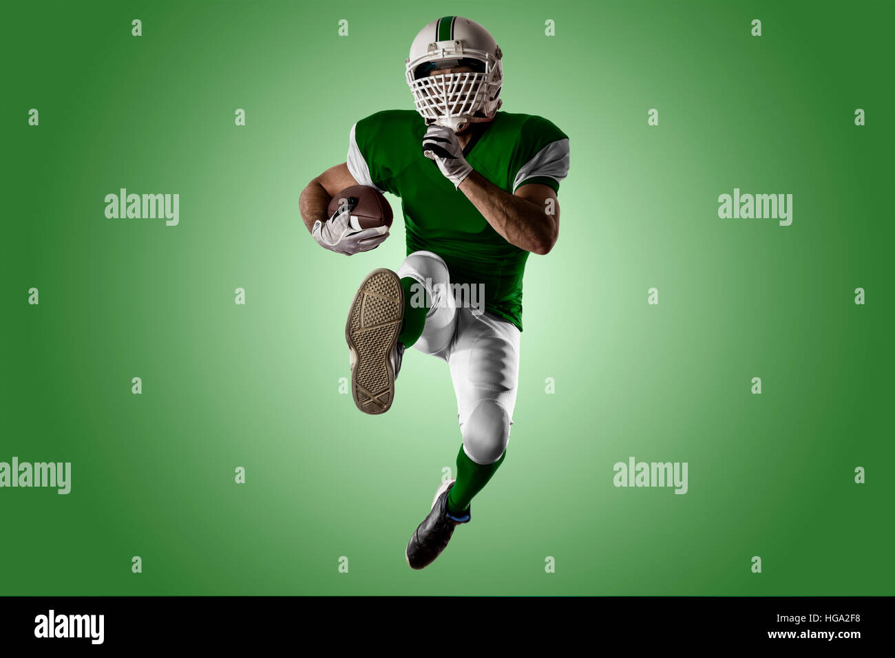 Football Player with a green uniform Running on a green background ...