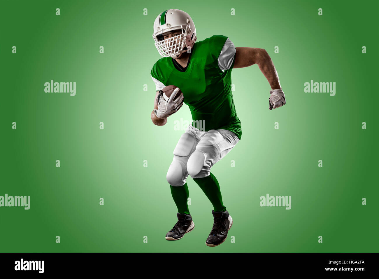 Football Player with a green uniform Running on a green background ...