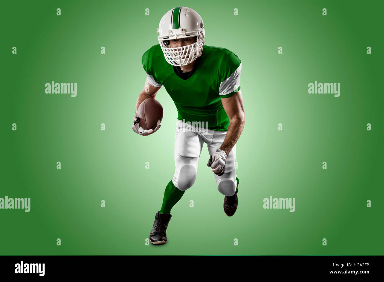 Football Player with a green uniform Running on a green background ...