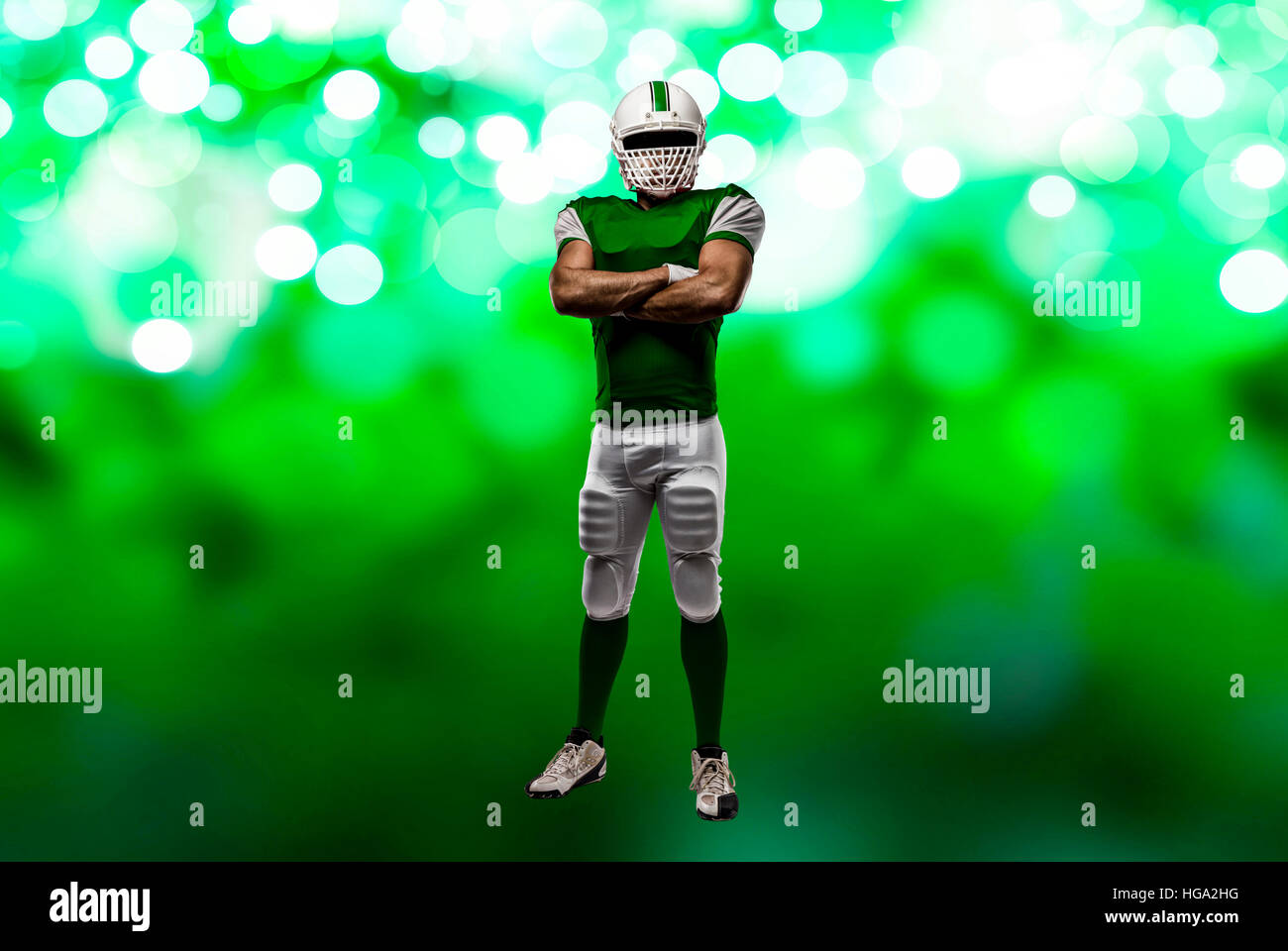 Football Player with a green uniform on a green lights background Stock ...