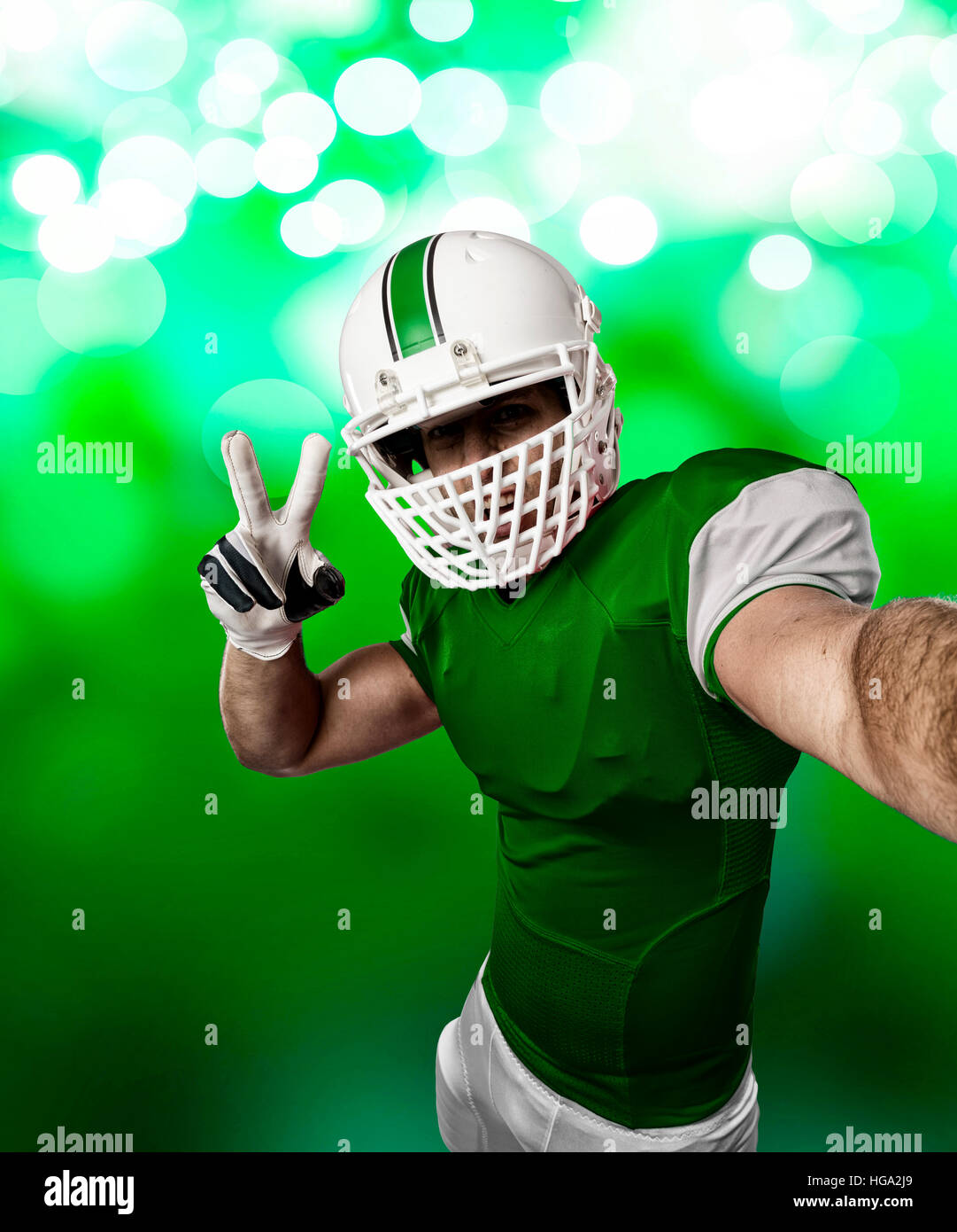 Football Player with a green uniform making a selfie on a green lights ...