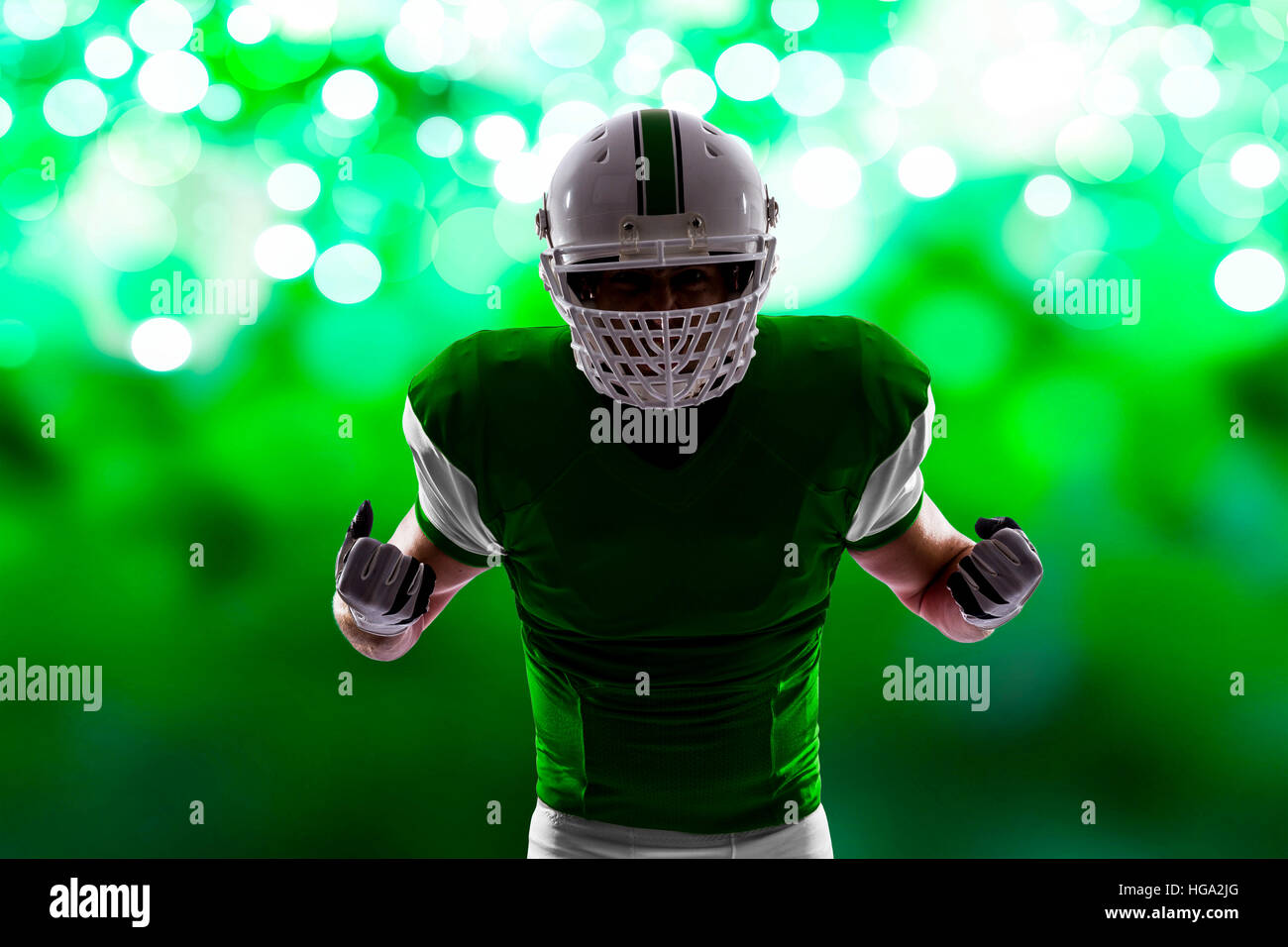 Football Player with a green uniform on a green lights background Stock ...