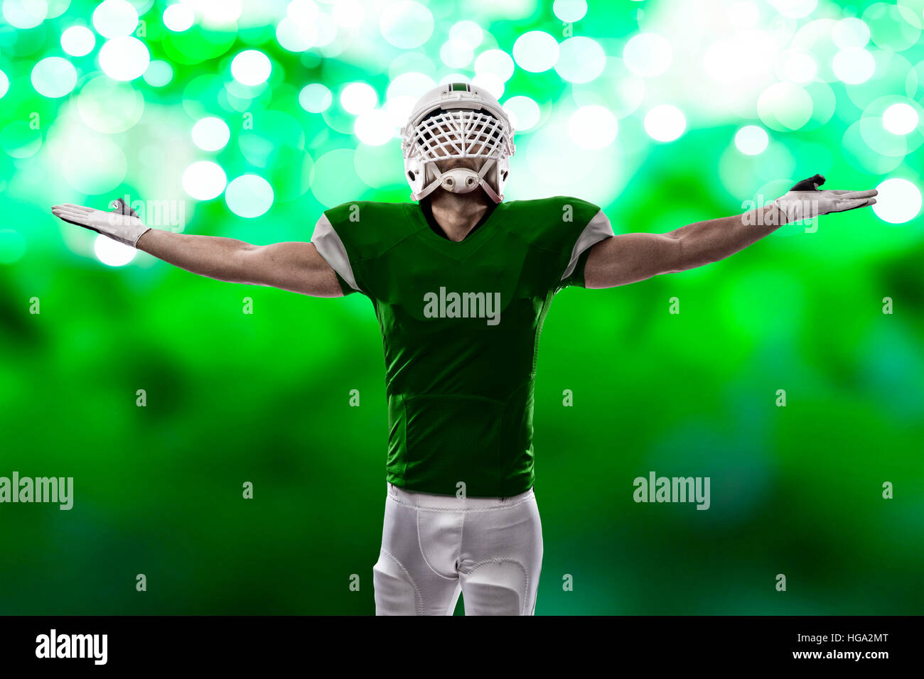 Football Player with a green uniform celebrating, on a green lights ...