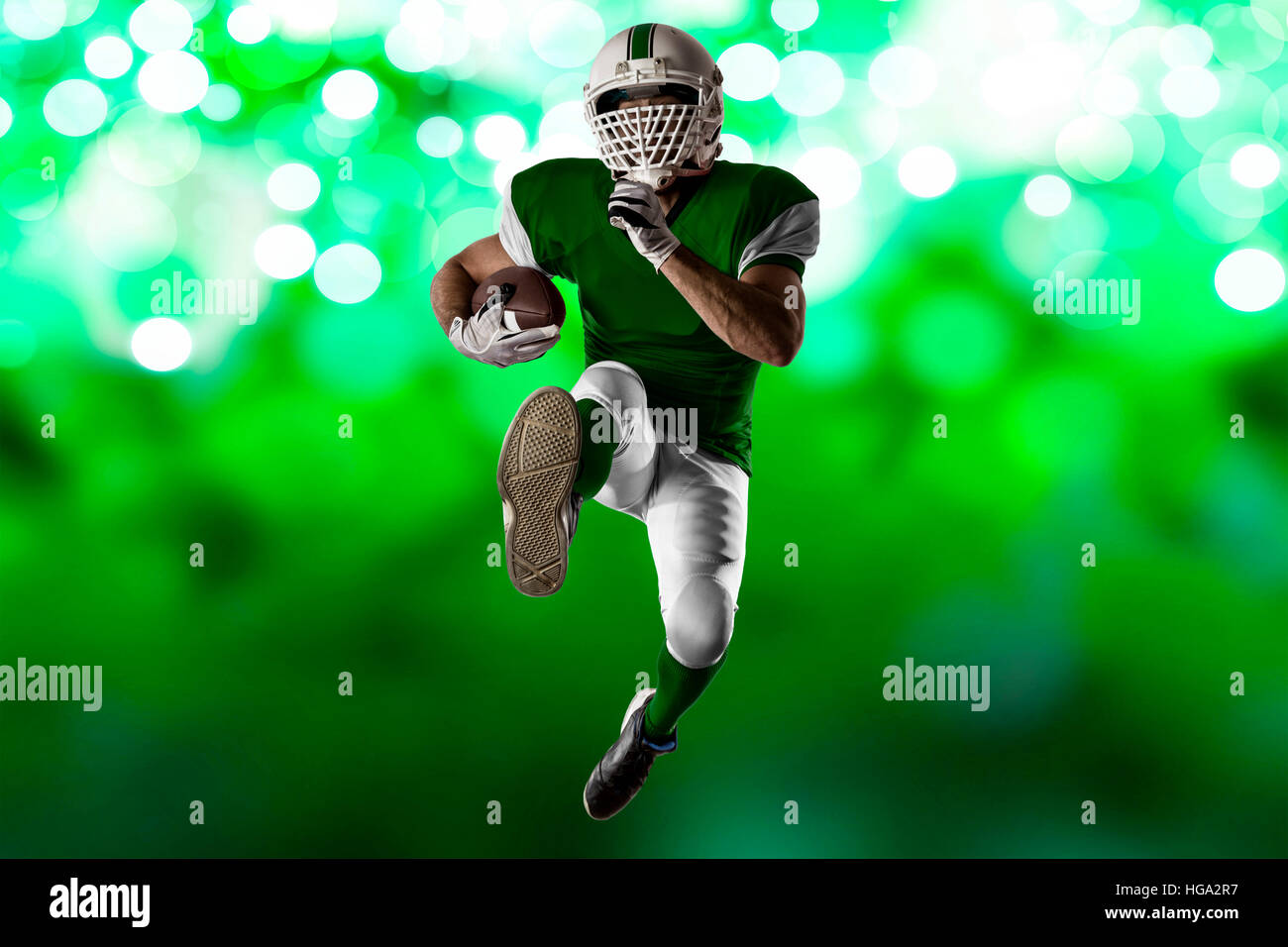 Football Player with a green uniform Running on a green lights ...