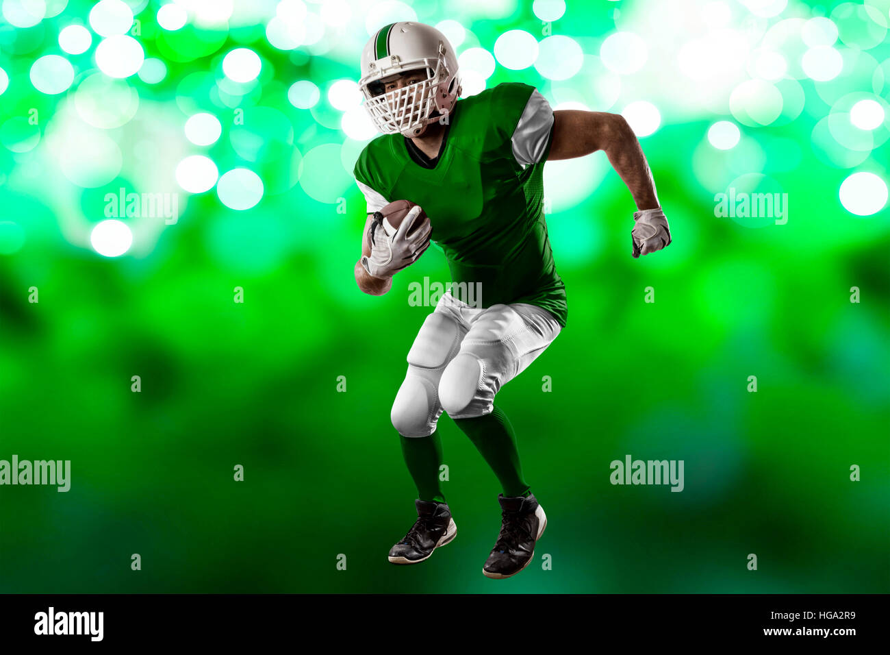 Football Player with a green uniform Running on a green lights ...