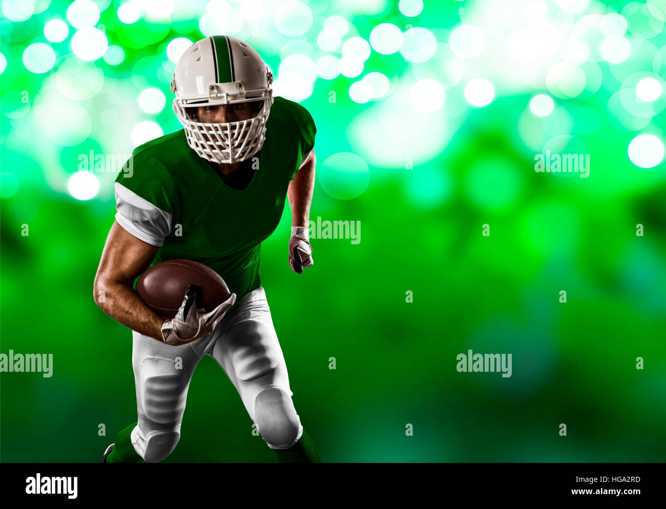 Football Player with a green uniform Running on a green lights ...