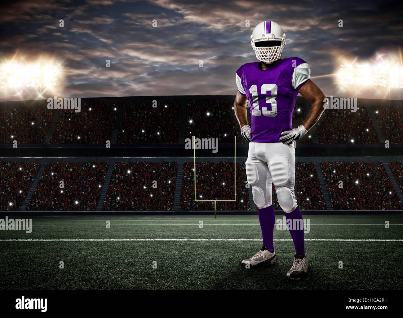 Football Player with a purple uniform on a stadium Stock Photo - Alamy
