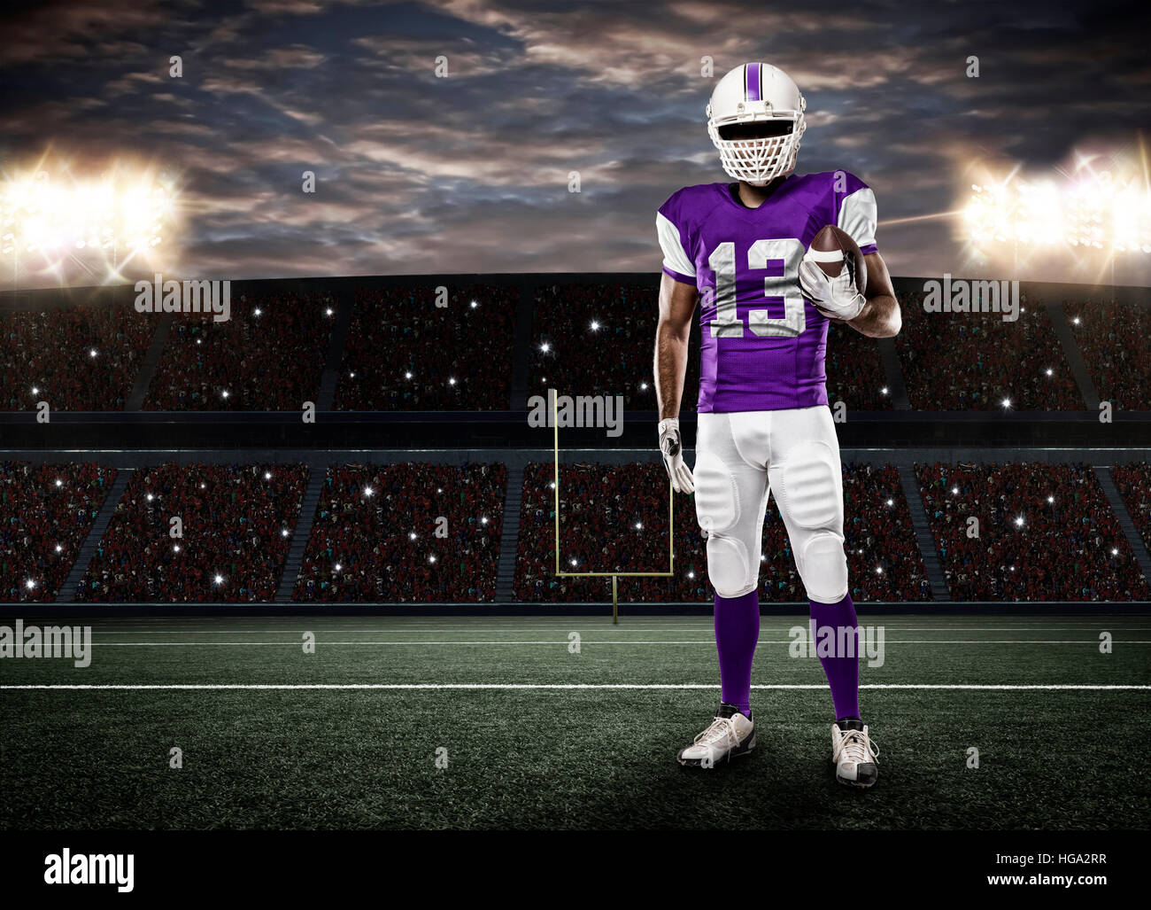 Football Player with a purple uniform on a stadium Stock Photo - Alamy