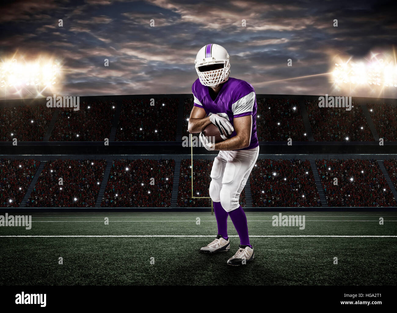 Football Player with a purple uniform on a stadium Stock Photo - Alamy