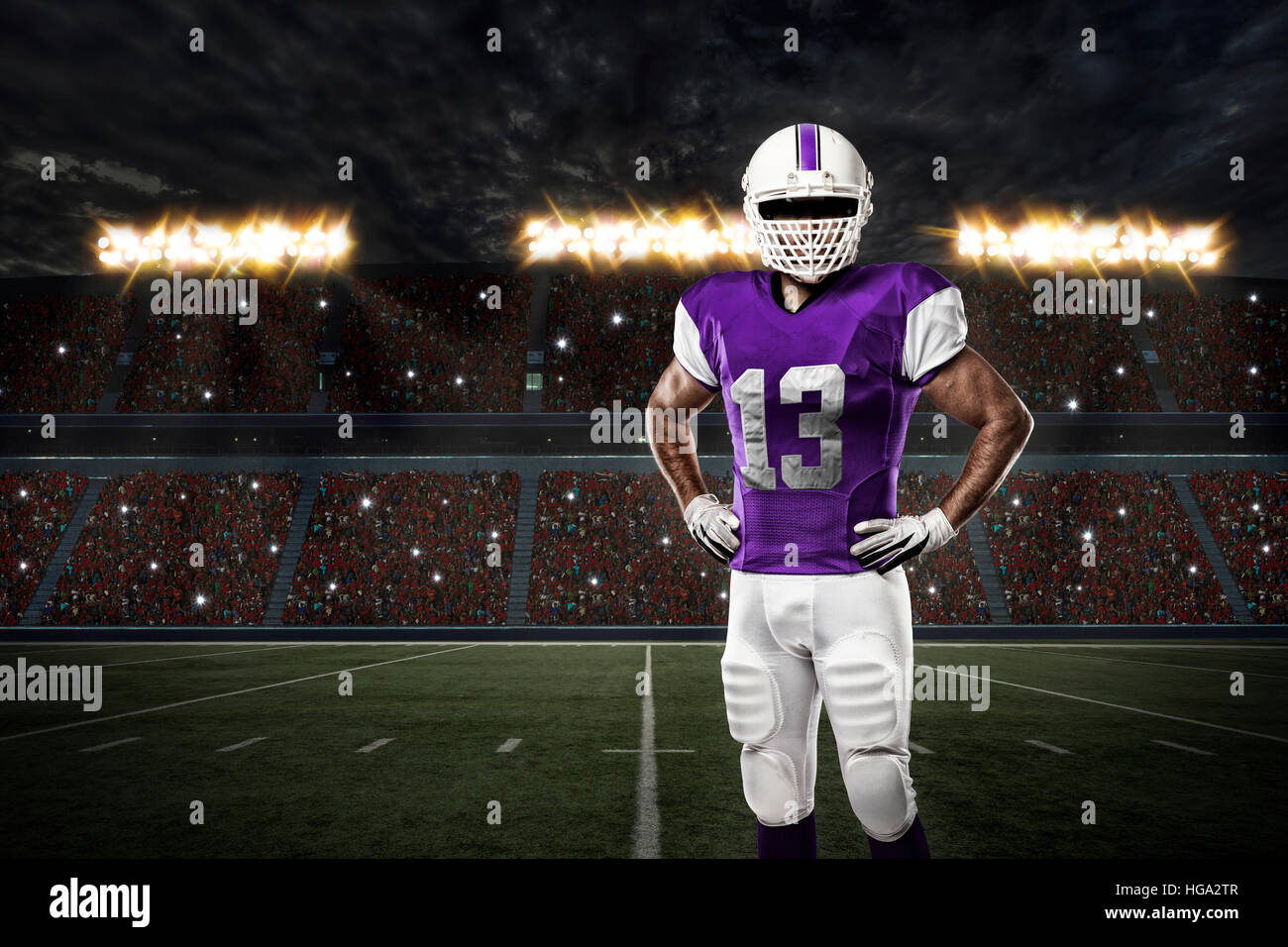 Football Player with a purple uniform on a stadium Stock Photo - Alamy