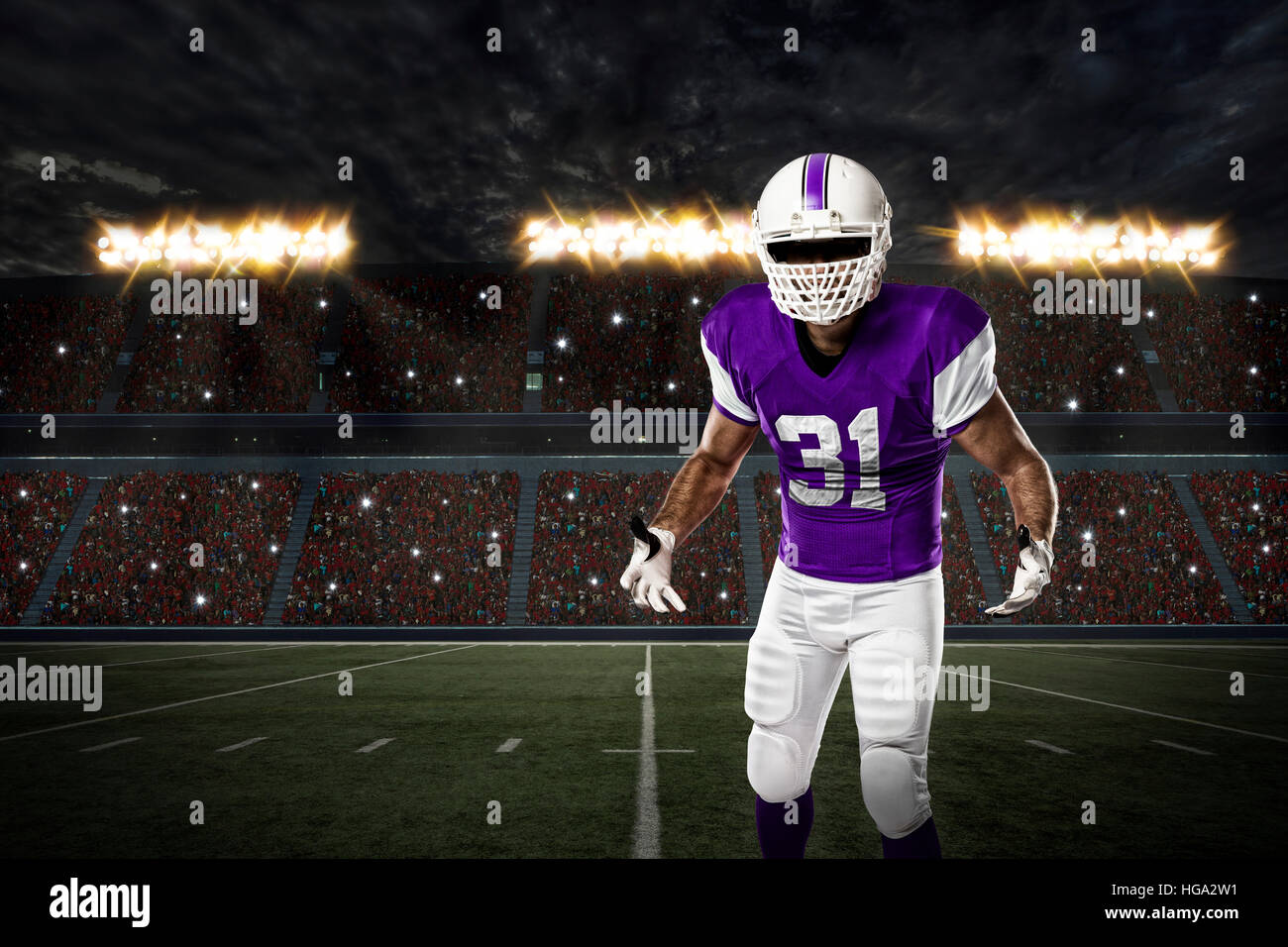 Football Player with a purple uniform on a stadium Stock Photo - Alamy