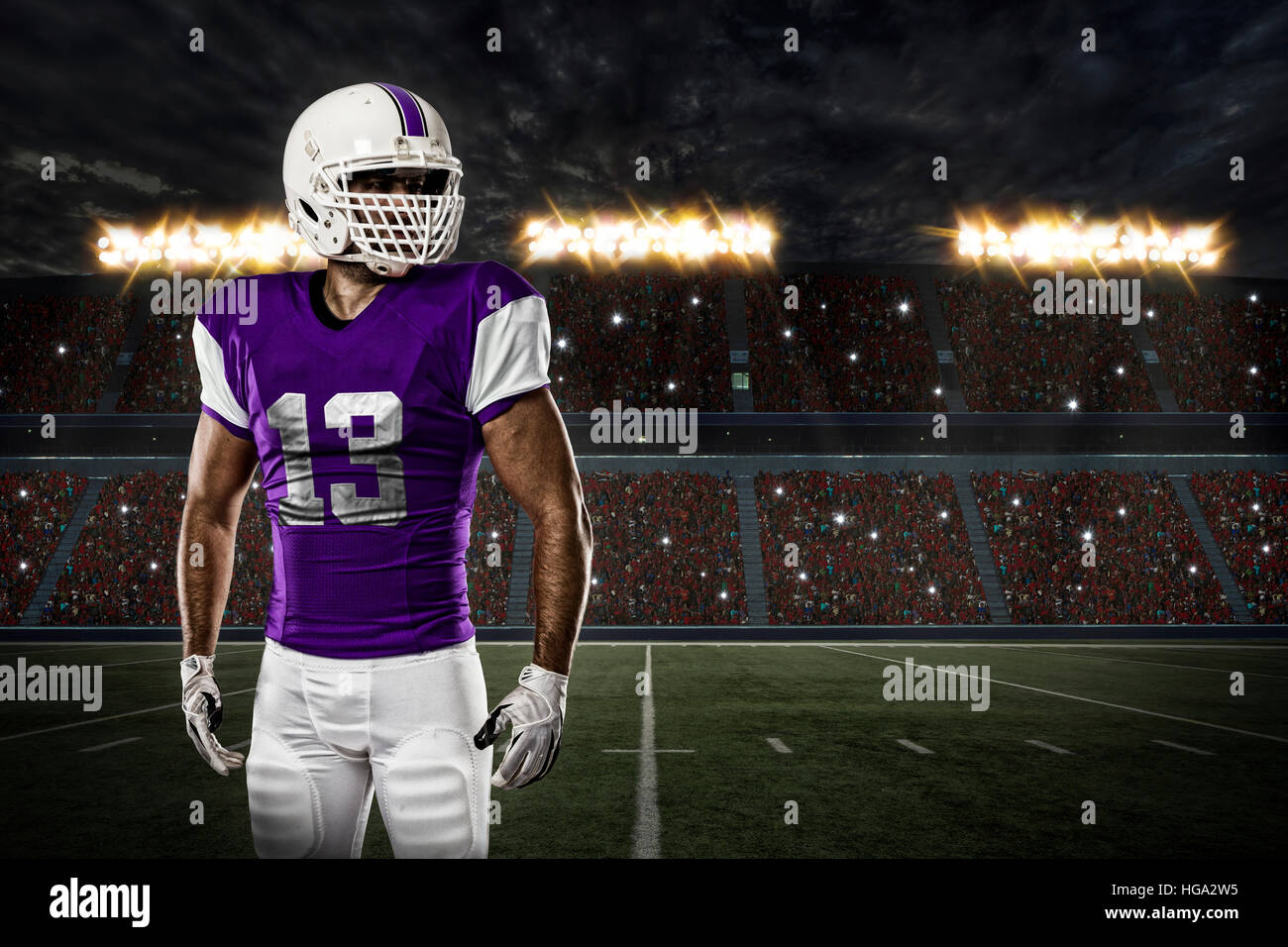 Football Player with a purple uniform on a stadium Stock Photo - Alamy