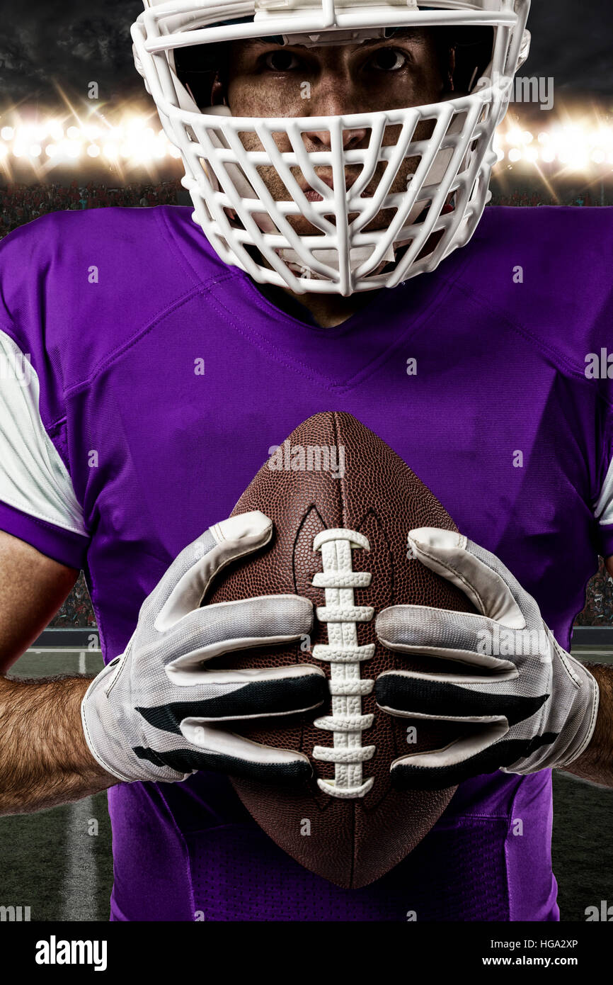 Close up of a Football purple with a white uniform on a stadium Stock ...