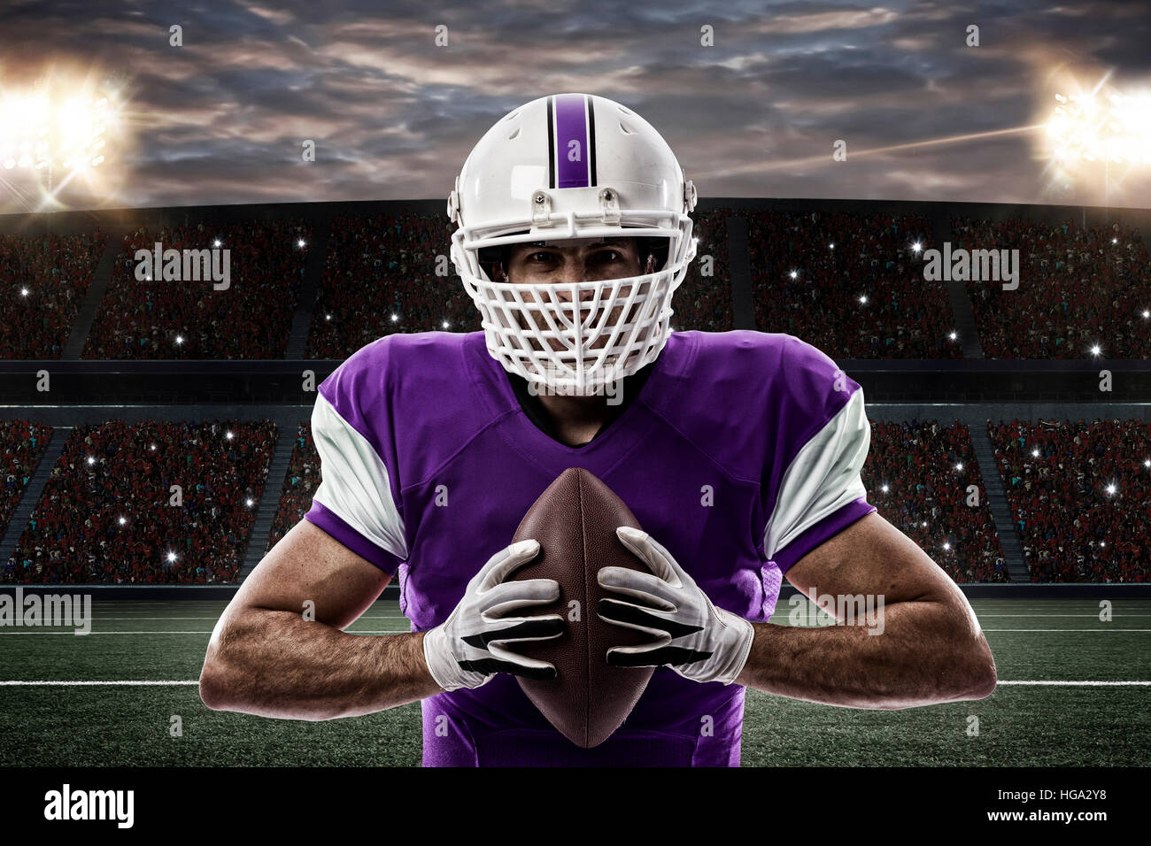 Football Player with a purple uniform on a stadium Stock Photo - Alamy