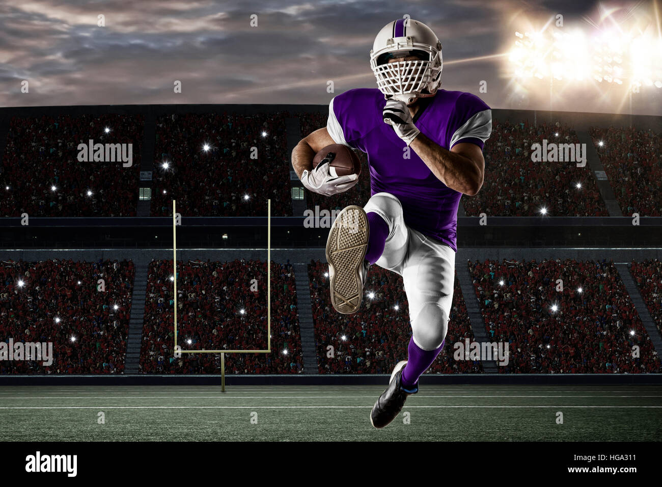 Football Player with a purple uniform running on a stadium Stock Photo ...