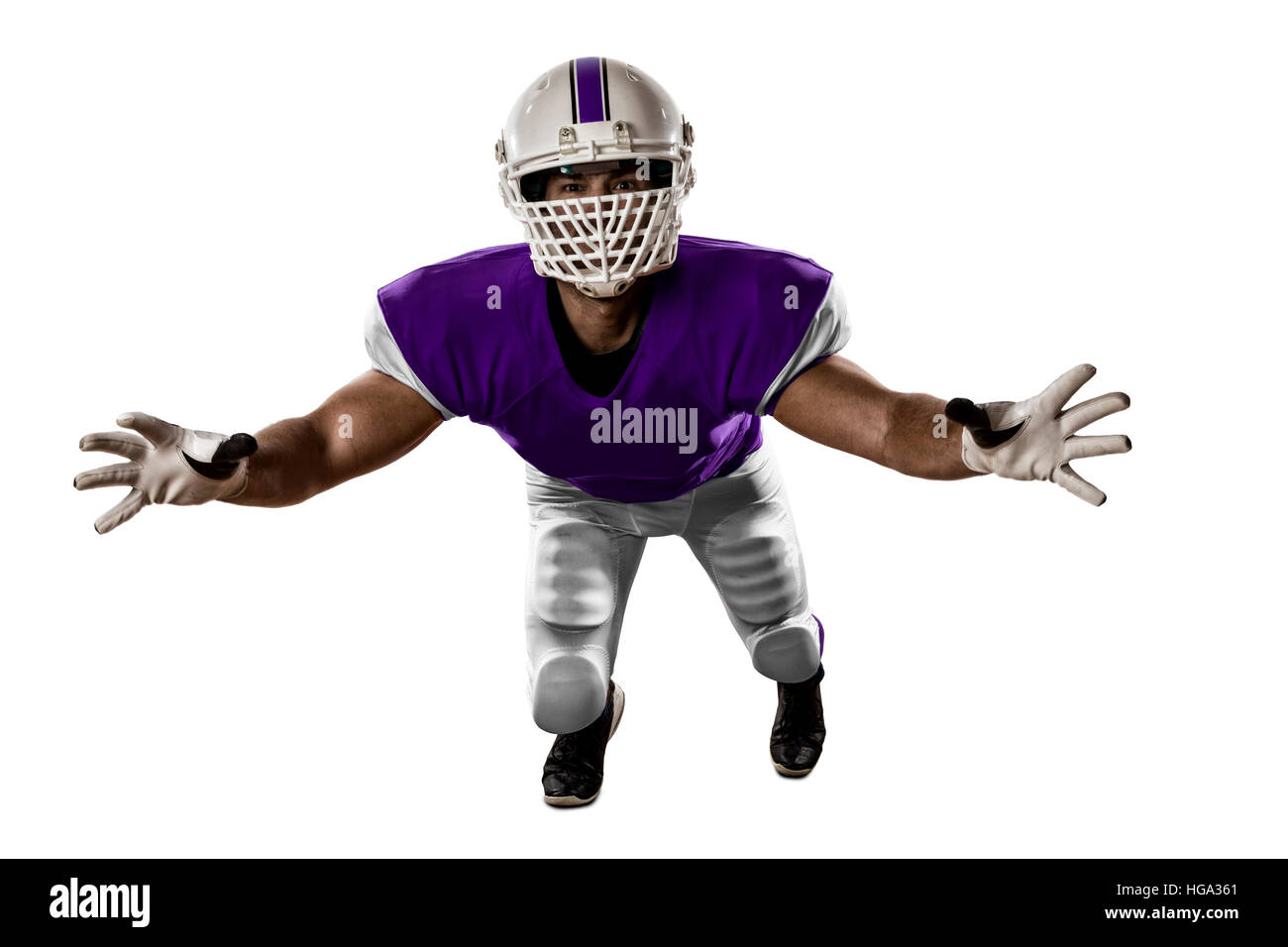 Football Player with a purple uniform making a tackle on a white ...