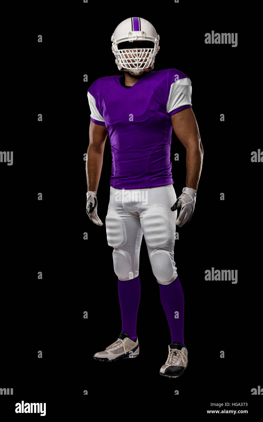 Football Player with a purple uniform on a black background Stock Photo ...