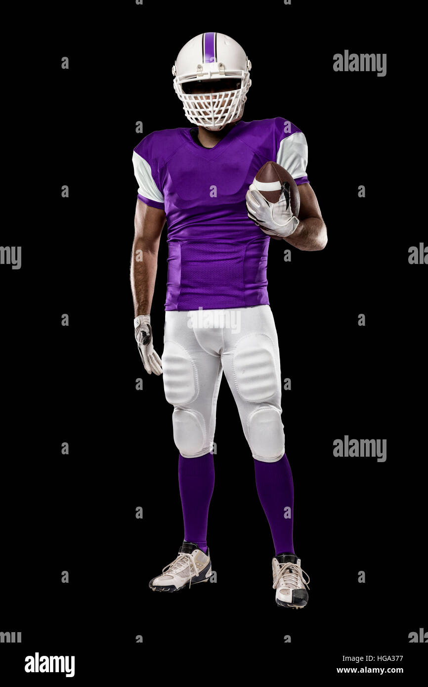 Football Player with a purple uniform on a black background Stock Photo ...