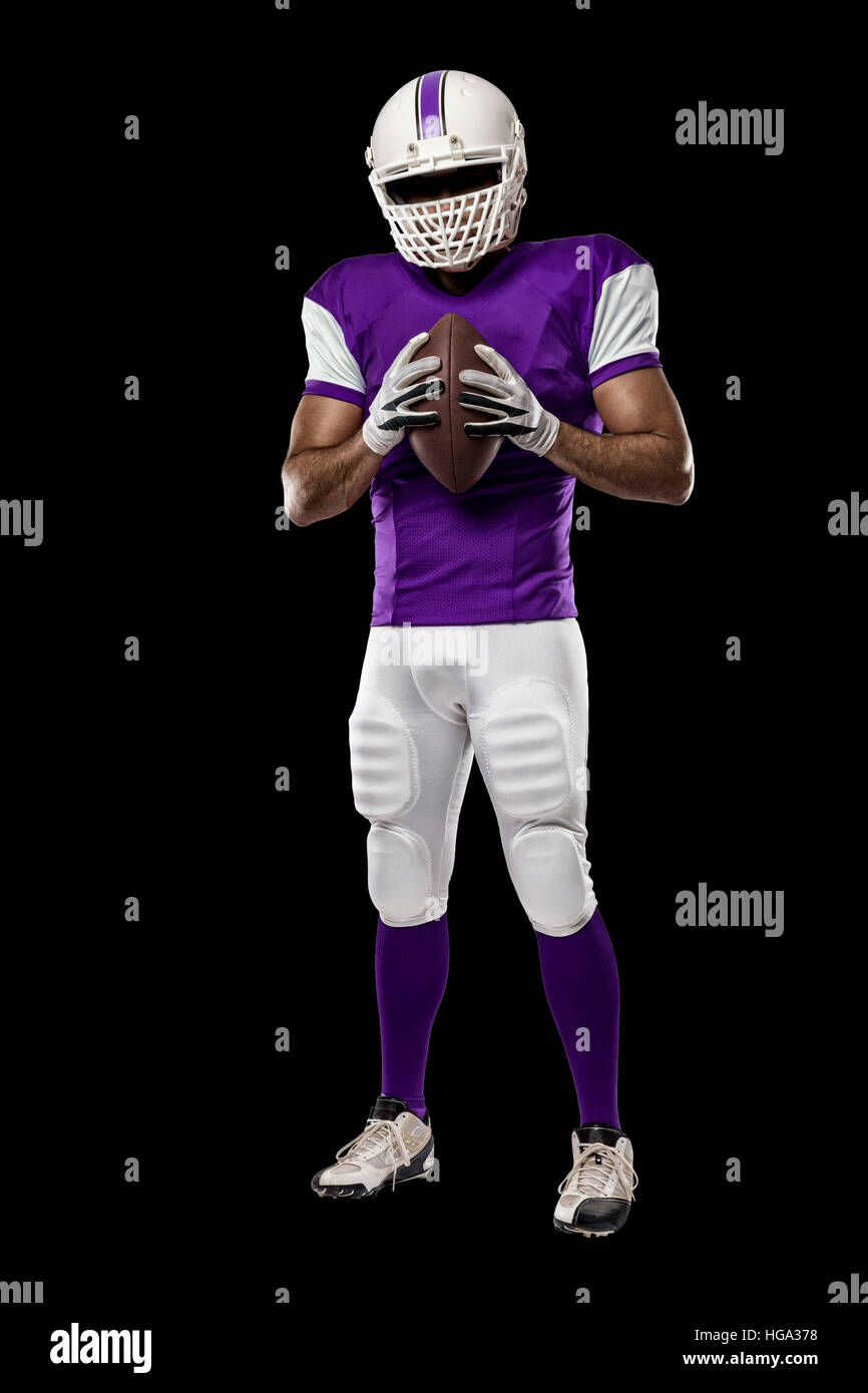 Football Player with a purple uniform on a black background Stock Photo ...