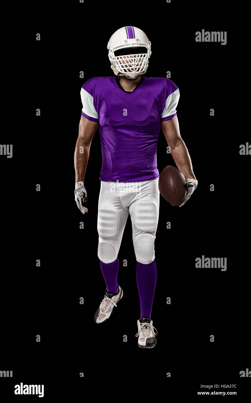 Football Player with a purple uniform on a black background Stock Photo ...