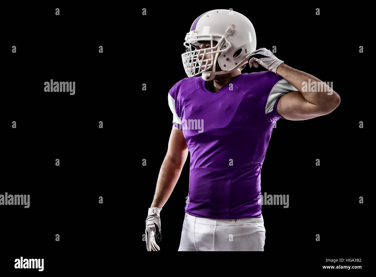 Football Player with a purple uniform on a black background Stock Photo ...