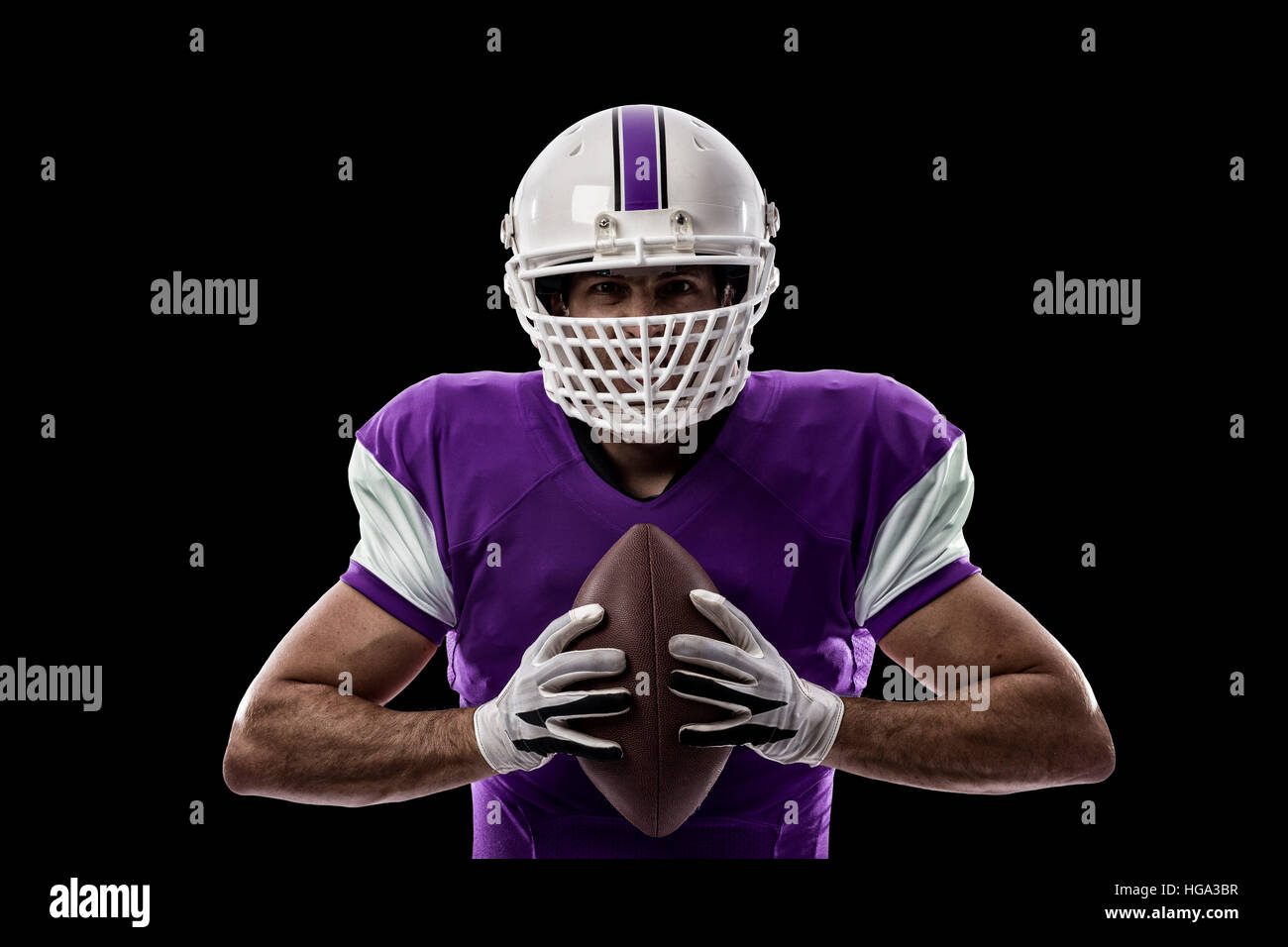 Football Player with a purple uniform on a black background Stock Photo ...